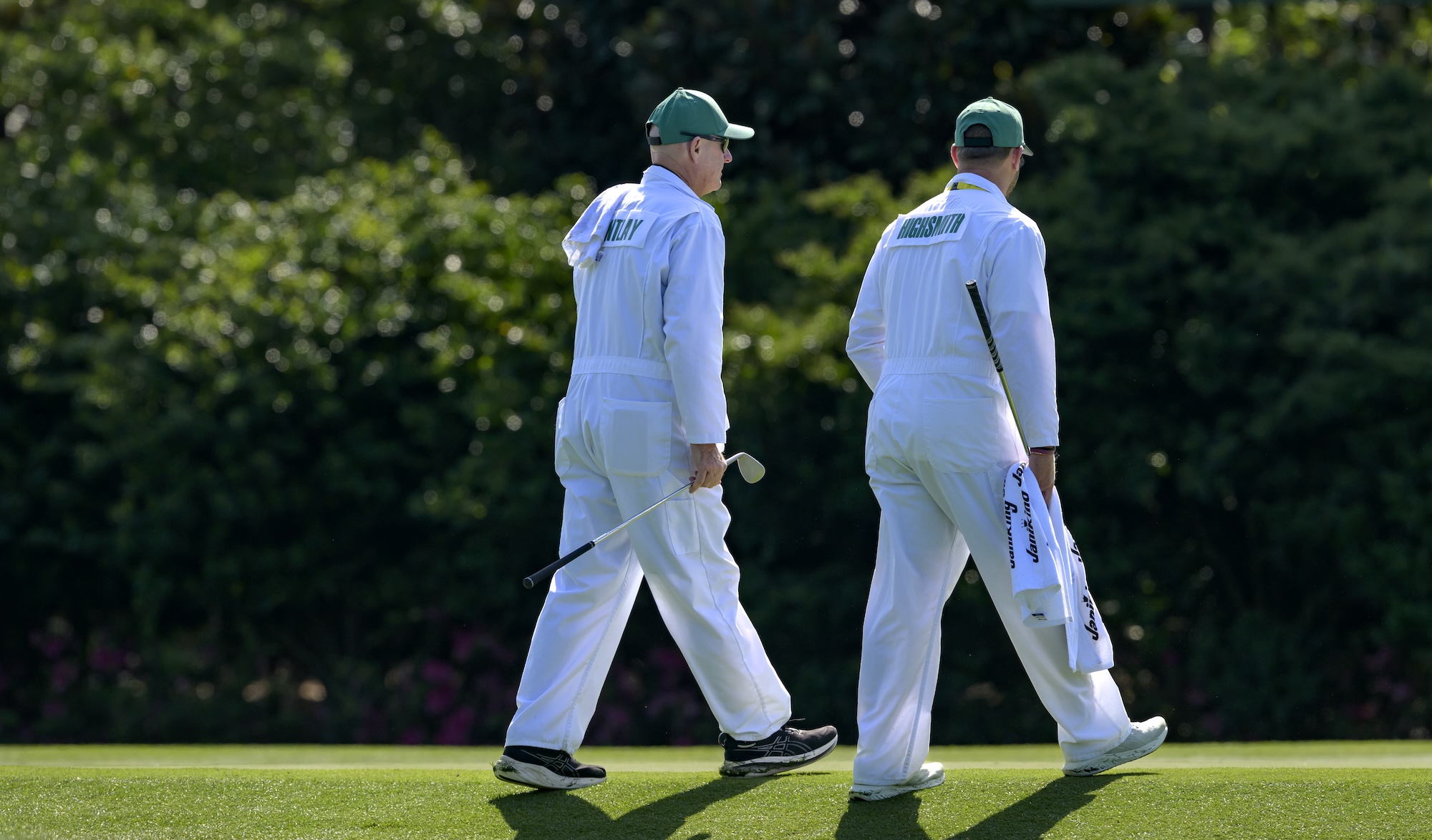 Why do caddies wear white boiler suits at the Masters?